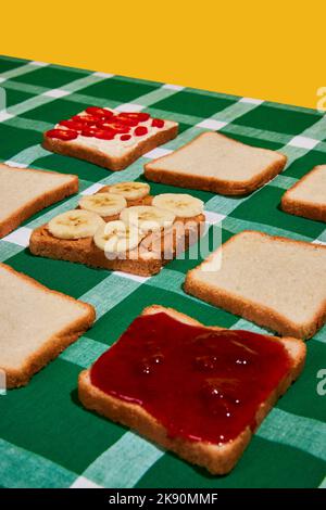 Original composition with uncooked bread toasts on plaid green and ...