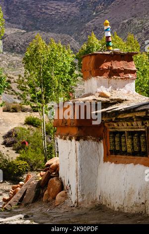 A vertical shot of an Old Tibetan Buddhist in traditional clothing at ...