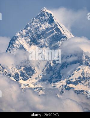 The Machapuchare AKA Fishtail Mountain snowy peak in clouds, Himalaya ...