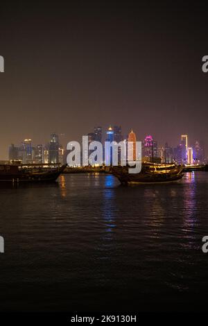 Slightly hazy Doha skyline at night, viewed across the water, from the ...