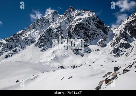 A low-angle of snowy ridged Kala Patthar, Sikkim, India, sunlit, clear ...