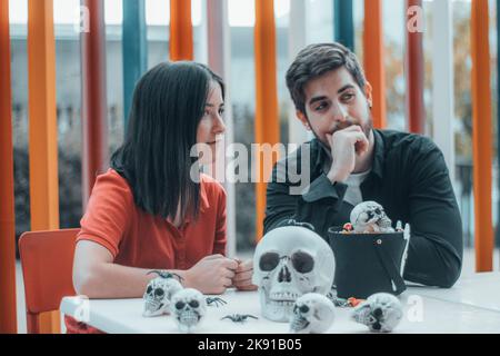 The people in masks talking about skull and bat halloween toy ...