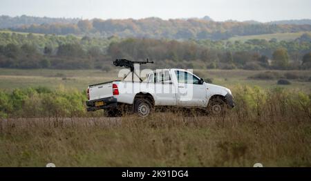 white toyota hilux pickup truck converted with an army large calibre ...