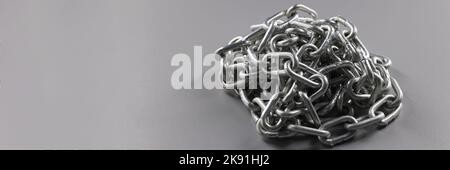 Grey chain folded in heap, steel metal iron chain on grey surface Stock ...