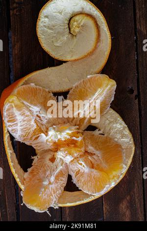 mandarin orange peeled in half on the peel in squares Stock Photo - Alamy