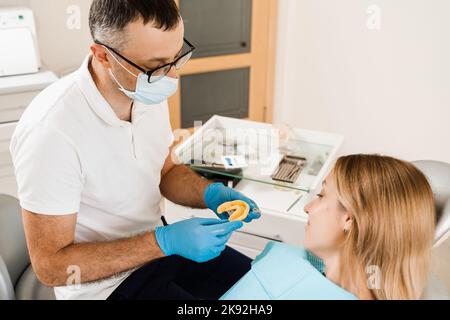 Procedure of creating dental prostheses, crowns and aligners. Doctor ...