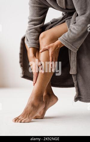 Deep vein thrombosis and varicose of african woman. Girl touching her ...