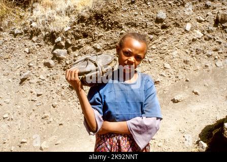 Axum, Ethiopia - July 1, 1998: Unidentified farm girl brings the food ...