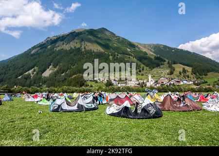 LATSCH, ITALY - AUG 1, 2009: people enjoy windsurfing at lake Levico in ...