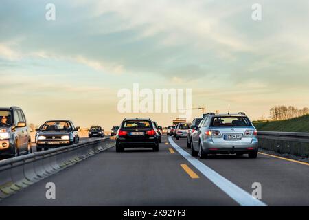 BURGAU, GERMANY - DEC 23, 2014: German highway A8 with cars in sunset ...