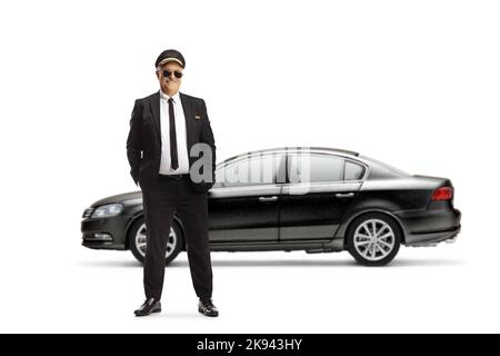 Chauffeur with sunglasses posing in front of a black car isolated on ...