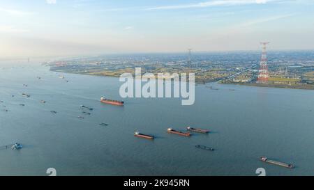 WUXI, CHINA - OCTOBER 25, 2022 - Cargo ships sail along the Yangtze River, flanked by the world ...