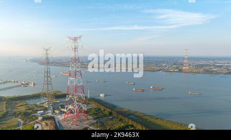 WUXI, CHINA - OCTOBER 25, 2022 - Cargo ships sail along the Yangtze River, flanked by the world ...