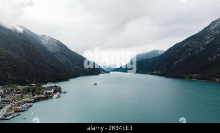 An aerial of the Achen lake's coastline with boats in Achensee region ...