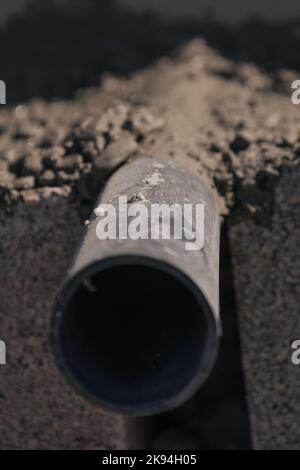A vertical shot of a sewer pipe being built under ground Stock Photo ...