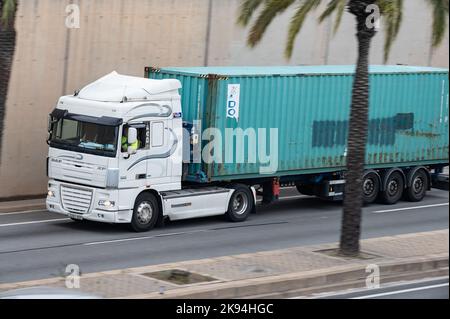 A white DAF XF truck loading a white container trailer along Barcelona ...