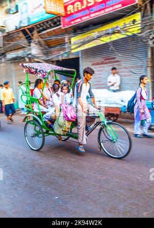 DELHI, INDIA - OCT 16: Rickshaw rider transports heavy goods on OCT 16 ...