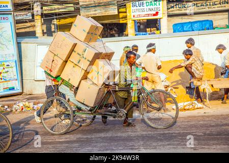 DELHI, INDIA - OCT 16: Rickshaw rider transports heavy goods on OCT 16 ...