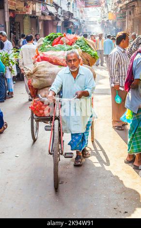 DELHI, INDIA - OCT 16: Rickshaw rider transports heavy goods on OCT 16 ...