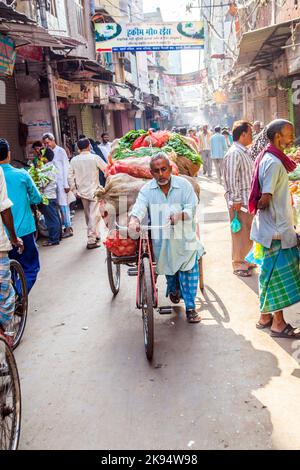 DELHI, INDIA - OCT 16: Rickshaw rider transports heavy goods early ...