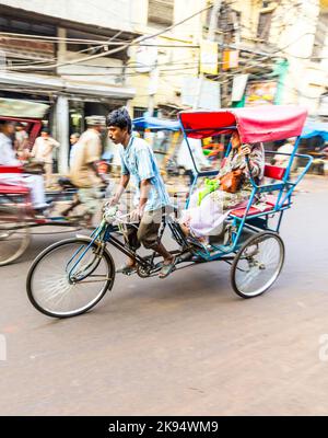 DELHI, INDIA - OCT 16: Rickshaw rider transports vegetables early ...
