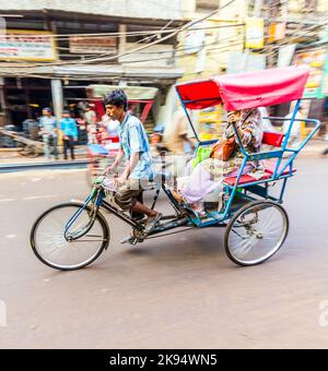 DELHI, INDIA - OCT 16: Rickshaw rider transports heavy goods early ...