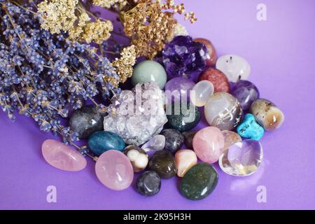A beautiful amethyst druse with a dry bouquet of lavender on a lilac ...
