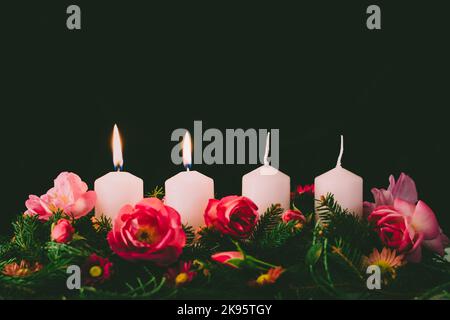 second burning advent candle on decorated rose flower pink advent ...