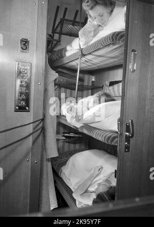 AB02C, 3rd grade sleeping car. The woman reads the newspaper and the ...