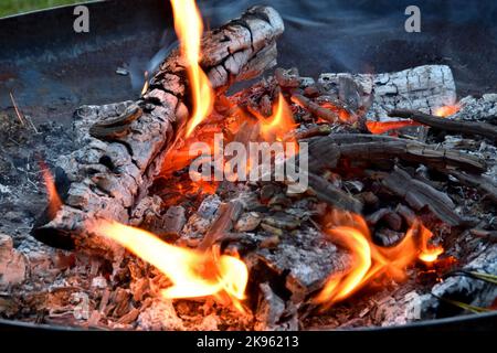 A glowing fire on disc grill Stock Photo - Alamy