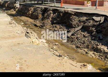 Asphalt road collapsed and cracks in the roadside, Road landslide ...