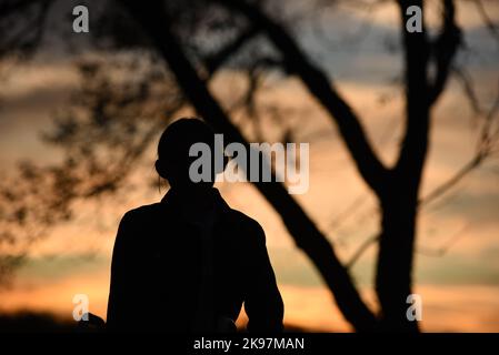 silhouette of person with sunset behind Stock Photo - Alamy