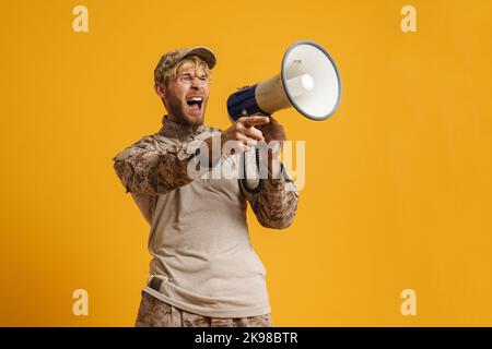 European military man wearing uniform shouting in megaphone isolated ...