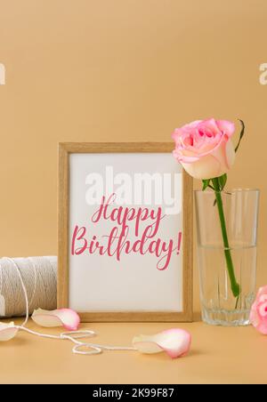 Delicate pink roses with spool of white cotton rope in heart shape on ...