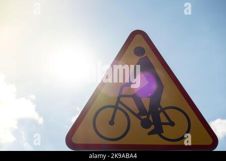 Triangle bicycle sign transit prohibited for bicycles on blurred park ...
