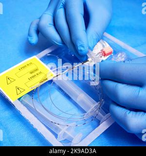 Injection of spinal anesthesia in preparation for surgery. The hands of ...