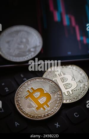 Various Bitcoin cryptocurrency coins with candle stick graph chart ...