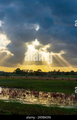 Sun rays breaking through clouds in blue sky over Punta Cana resort ...