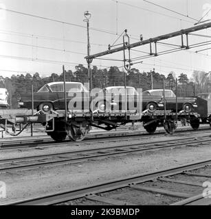 Passenger cars loaded on open carriage Stock Photo - Alamy