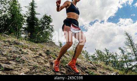 female runner running down mountain, summer trail marathon race Stock ...