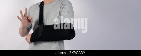 Broken arm. Arm Sling therapy support and covered around elbow first ...