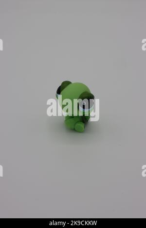 Tiny, cute plastic turtle animal figure on a white background ...
