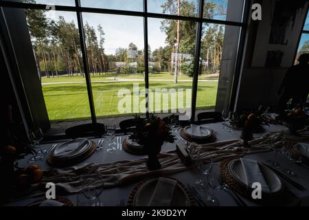 View of the lawn through the window of the banquet hall Stock Photo - Alamy