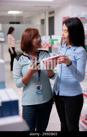 Asian customer looking at cardiology pills boxes to buy medicine ...
