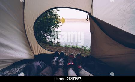 People, tourism and nature concept - Couple having fun on camping trip ...