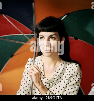 Fringed slim woman with colourful umbrella c1969 by Gilbert Adams (1906 ...