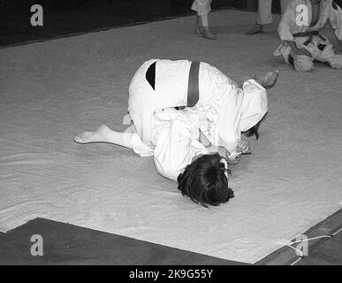 1970s, historical, inside, on a mat, two girls competing in the sport ...