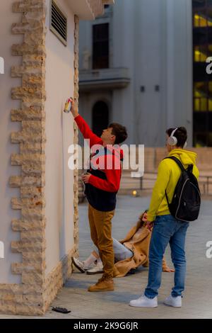 Group of amazing and attractive friends are preparing to spray paint ...