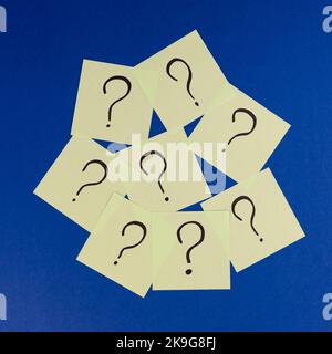 Drawn question marks on stickers, black background. Searching for truth ...