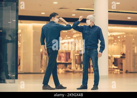 best friends in protective masks greeting each other Stock Photo - Alamy